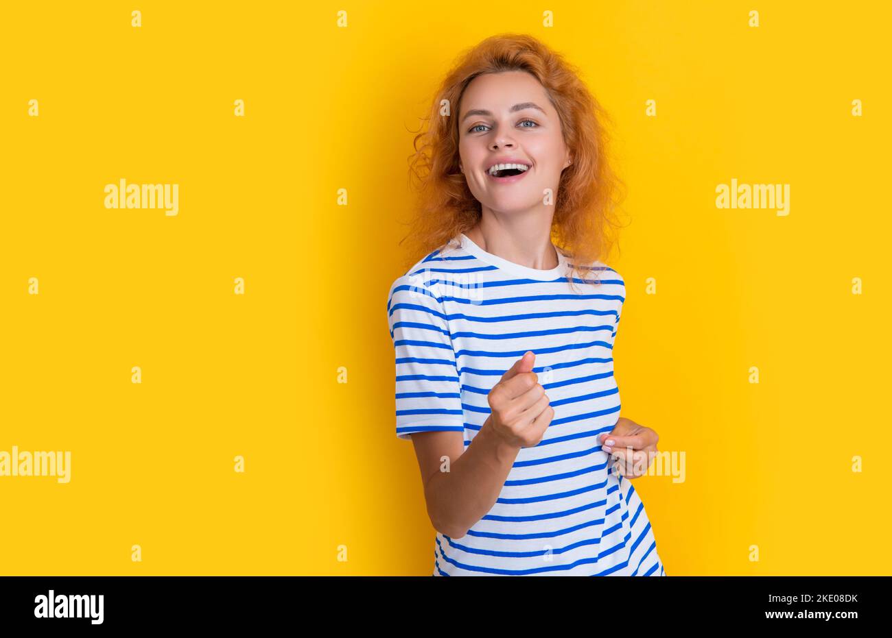 redhead woman dance isolated on yellow background. portrait of young ...