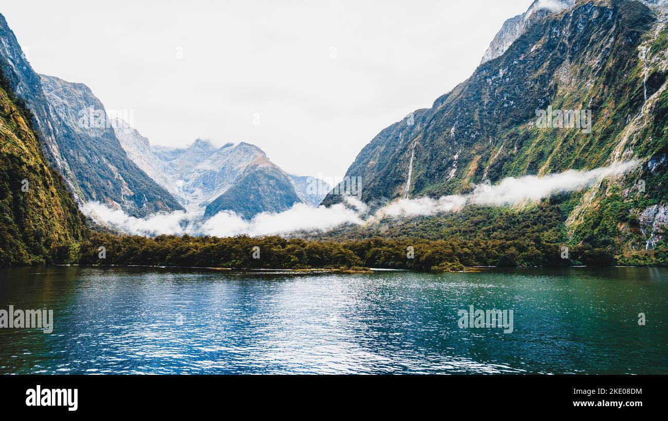 An aerial view of lake surrounded by rocky greenery mountains Stock ...