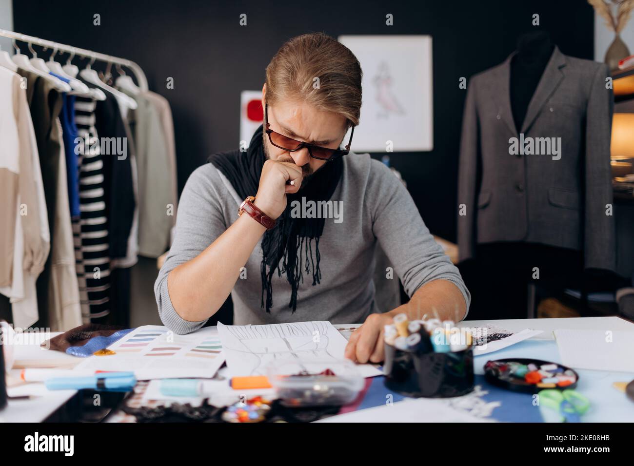 Focused designer creating clothes Stock Photo - Alamy