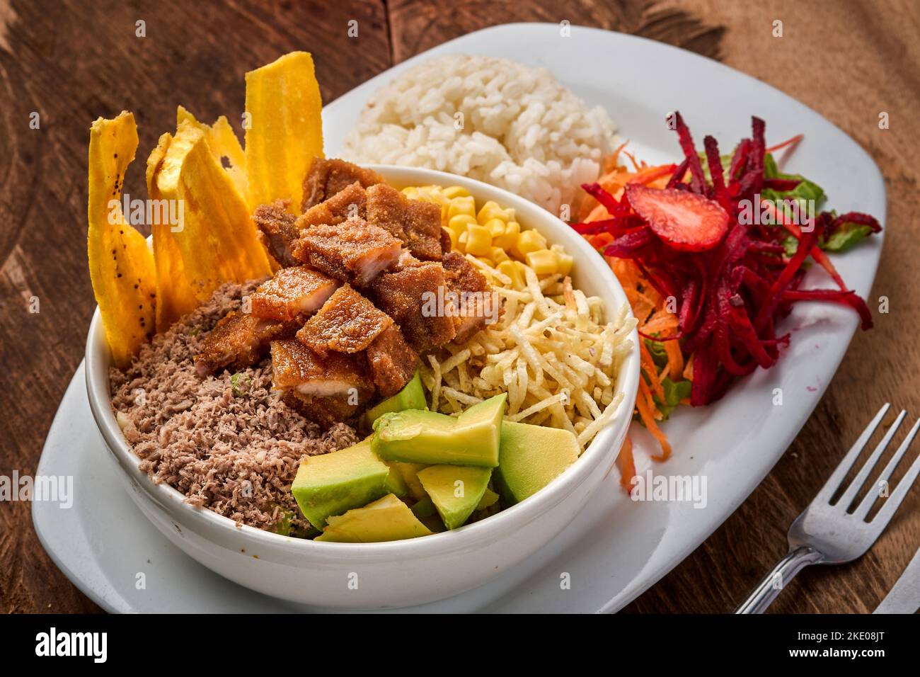 A top view of a plate with a traditional Bandeja paisa dish with ...