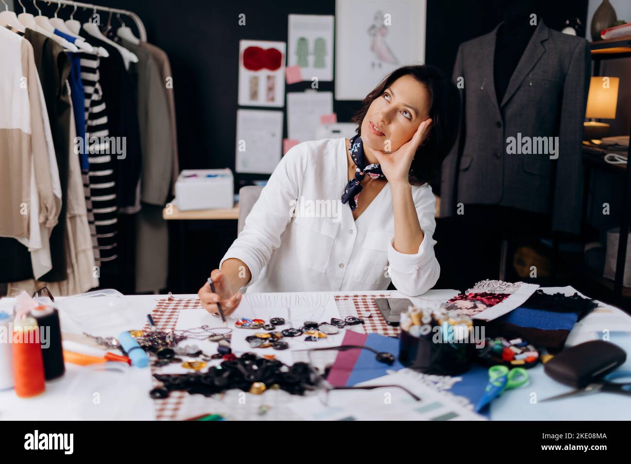 Dreamy dressmaker at atelier Stock Photo - Alamy