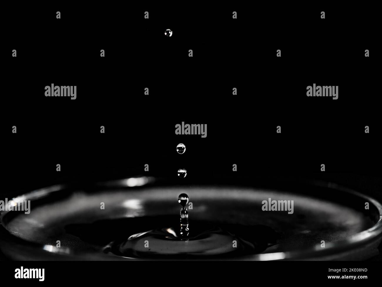 A water drop splashing into a cup Stock Photo - Alamy