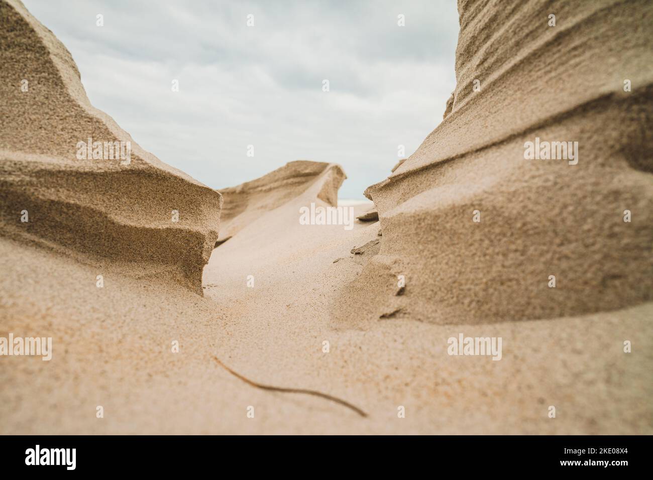 A closeup shot of amazing frozen sand pile sculptures on the coast near ...