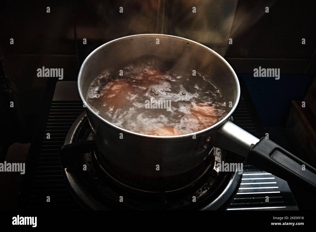 The water is boiling and smoke emitted from the pot egg cauldron on the ...
