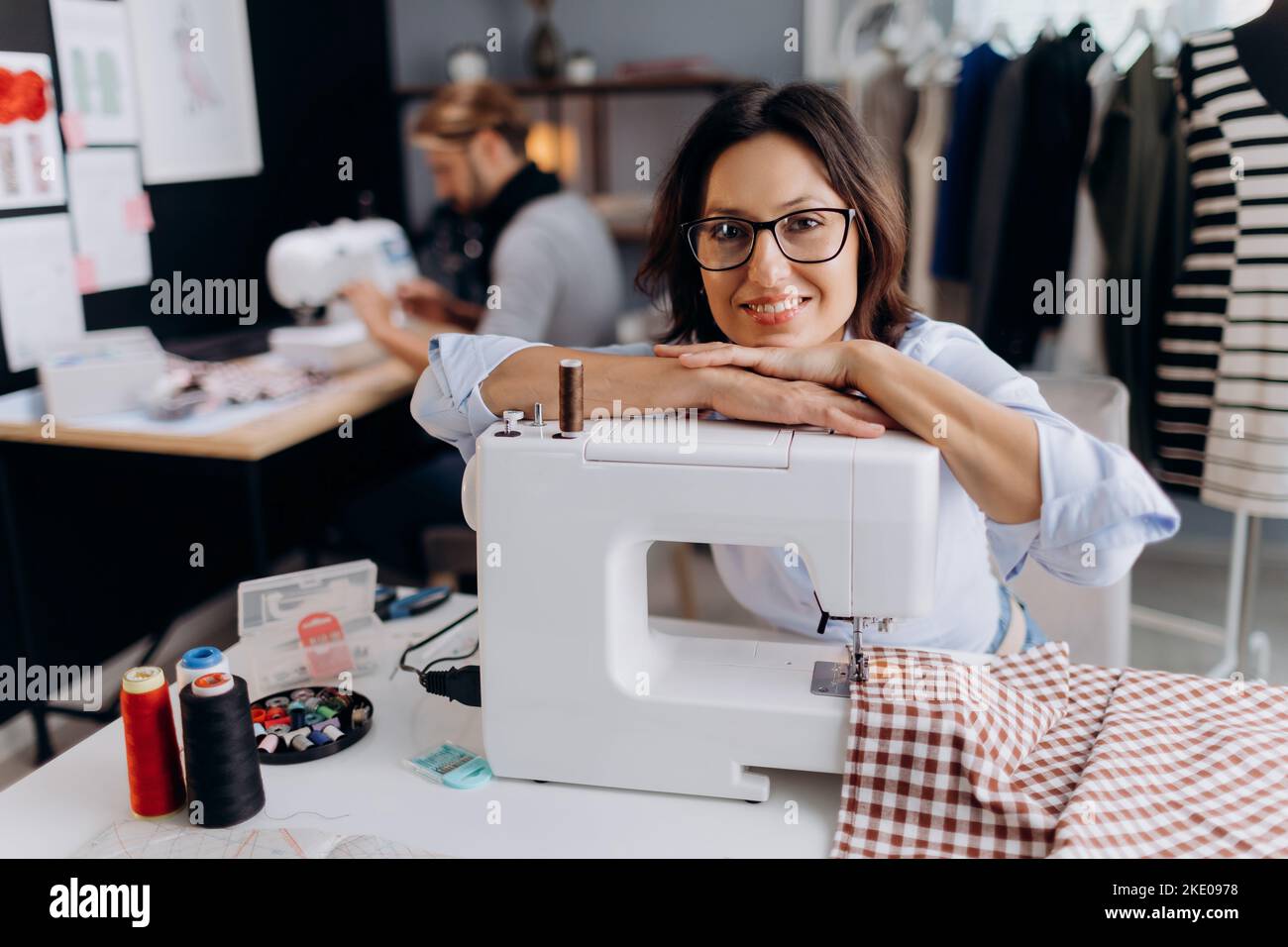 Female designer using sewing machine Stock Photo - Alamy