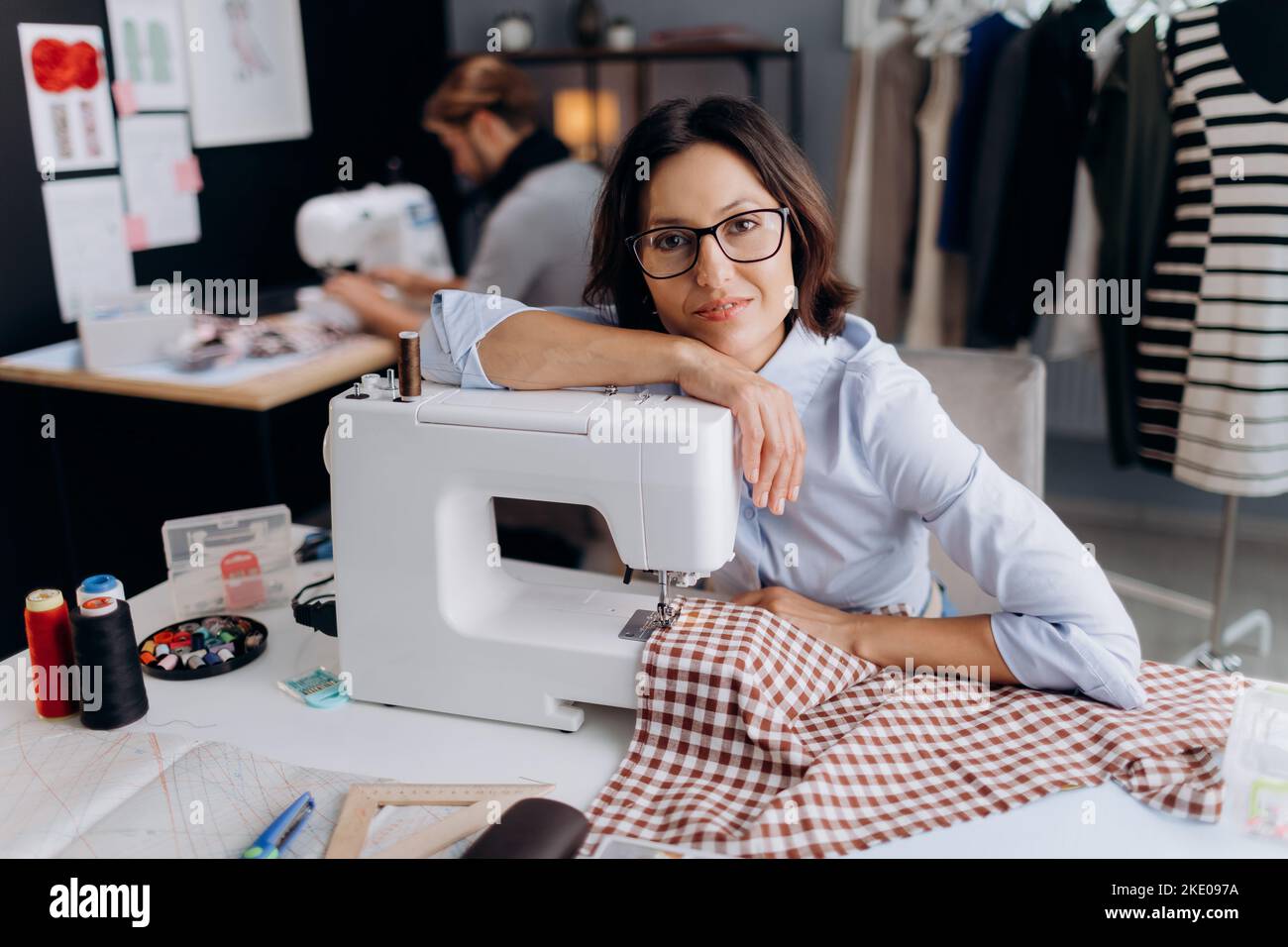 Dressmaker working on sewing machine Stock Photo - Alamy