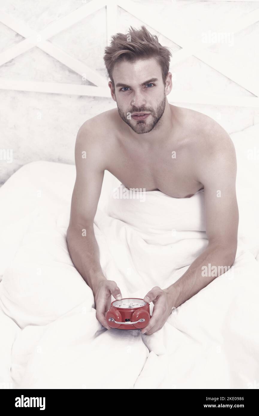 Man waking up early morning ringing alarm clock, turn off clock concept ...