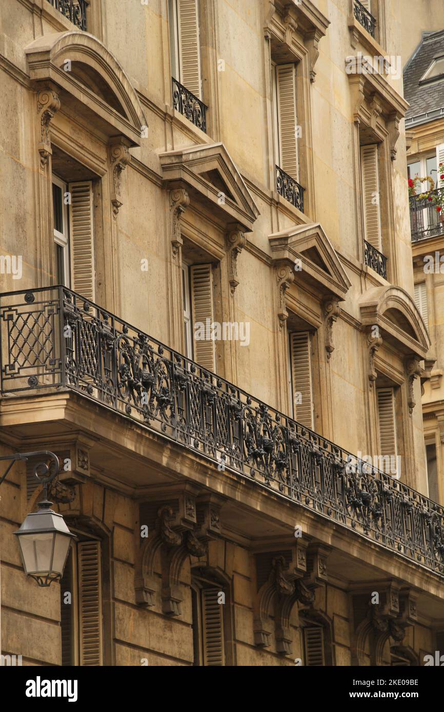 A vertical shot of a building facade with narrow long windows, Paris ...