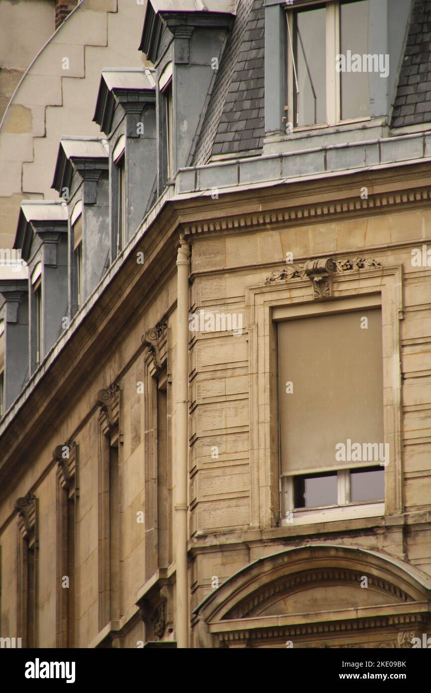 A vertical shot of a building facade with narrow long windows, Paris ...
