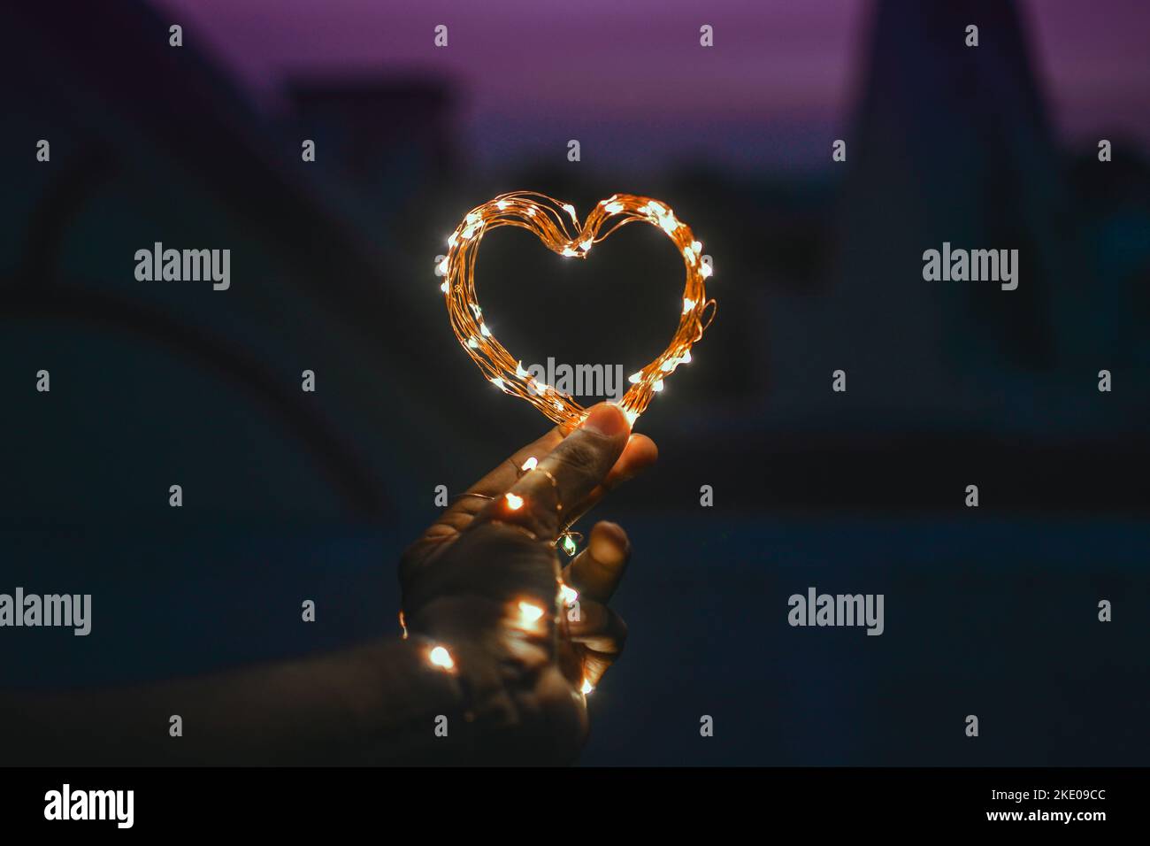 A closeup of human hand holding glowing heart shape Stock Photo - Alamy