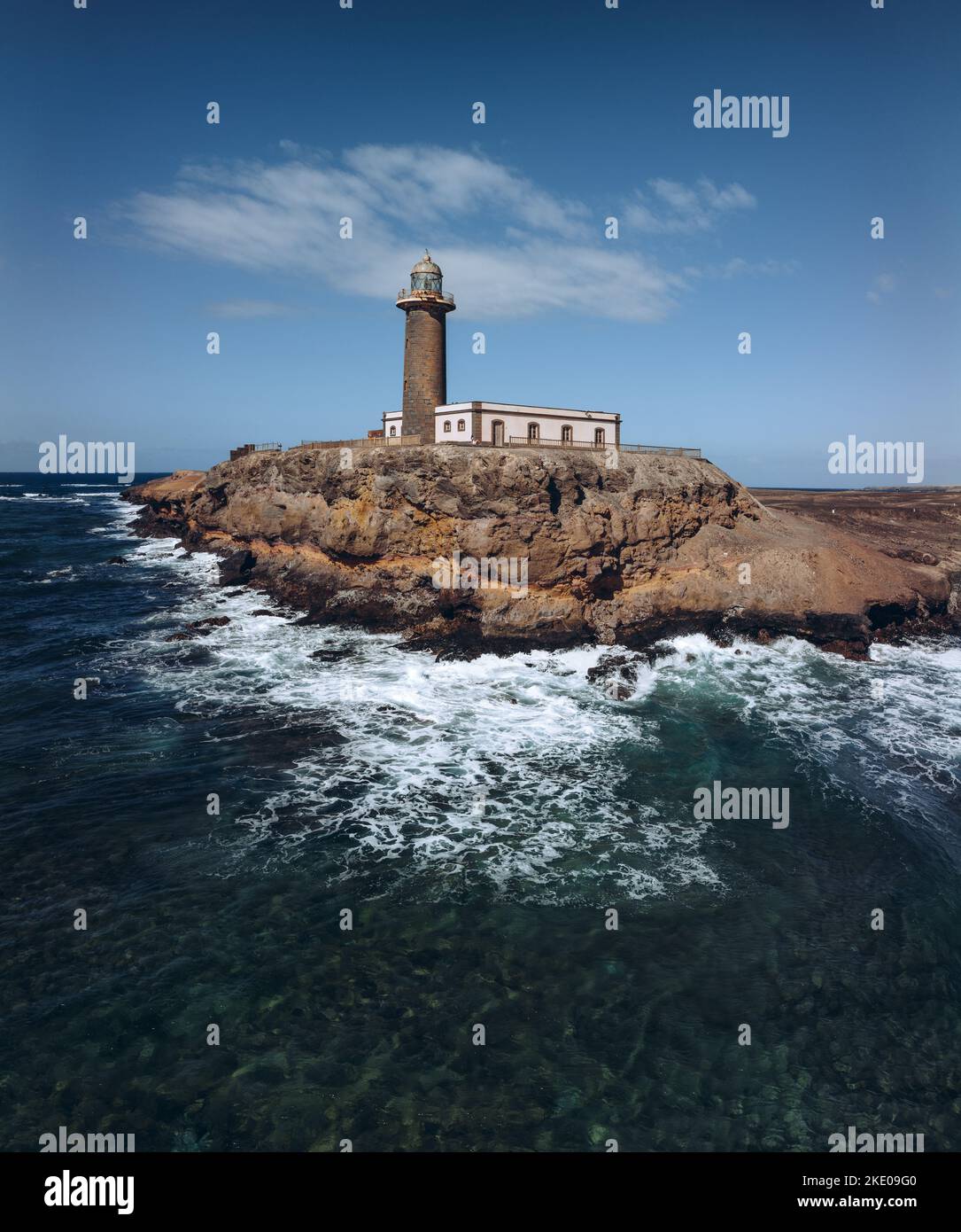 An aerial view of Jandia Lighthouse surrounded by water Stock Photo - Alamy
