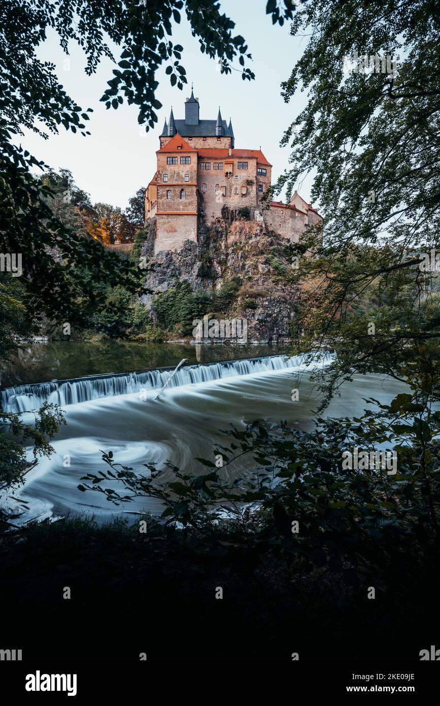 A beautiful view of the Kriebstein Castle through tree branches Stock ...