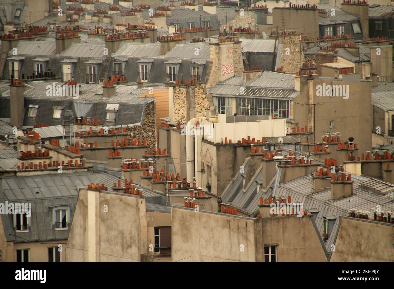 An aerial view of the roofs of houses with red chimneys in Paris ...