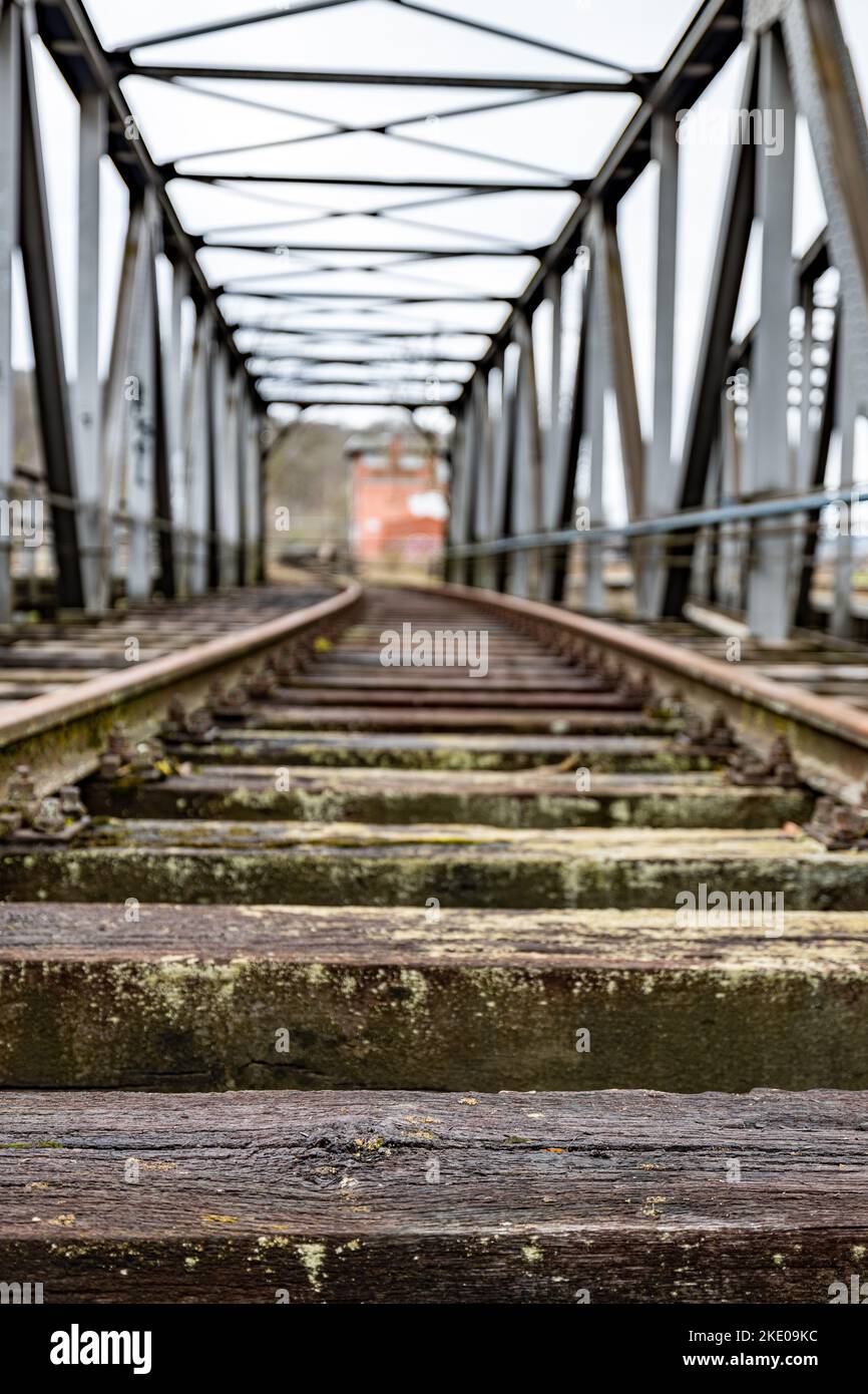 A vertical shot of a bridge with old wooden railways in daylight Stock ...