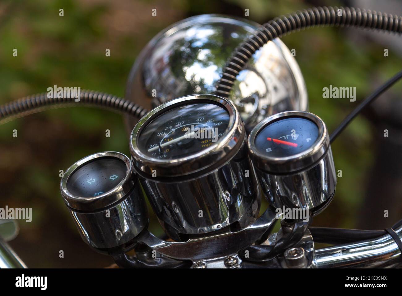 A closeup shot of a motorcycle dashboard panel with speedometer cluster ...