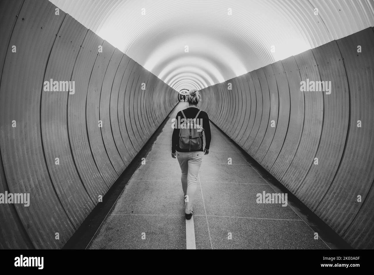 Woman walks through pedestrian Brunkenberg Tunnel in Stockholm, Sweden ...
