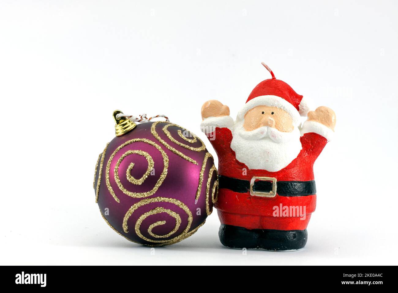 Dark red Christmas ball with gold stripes and a Santa claus isolated on ...