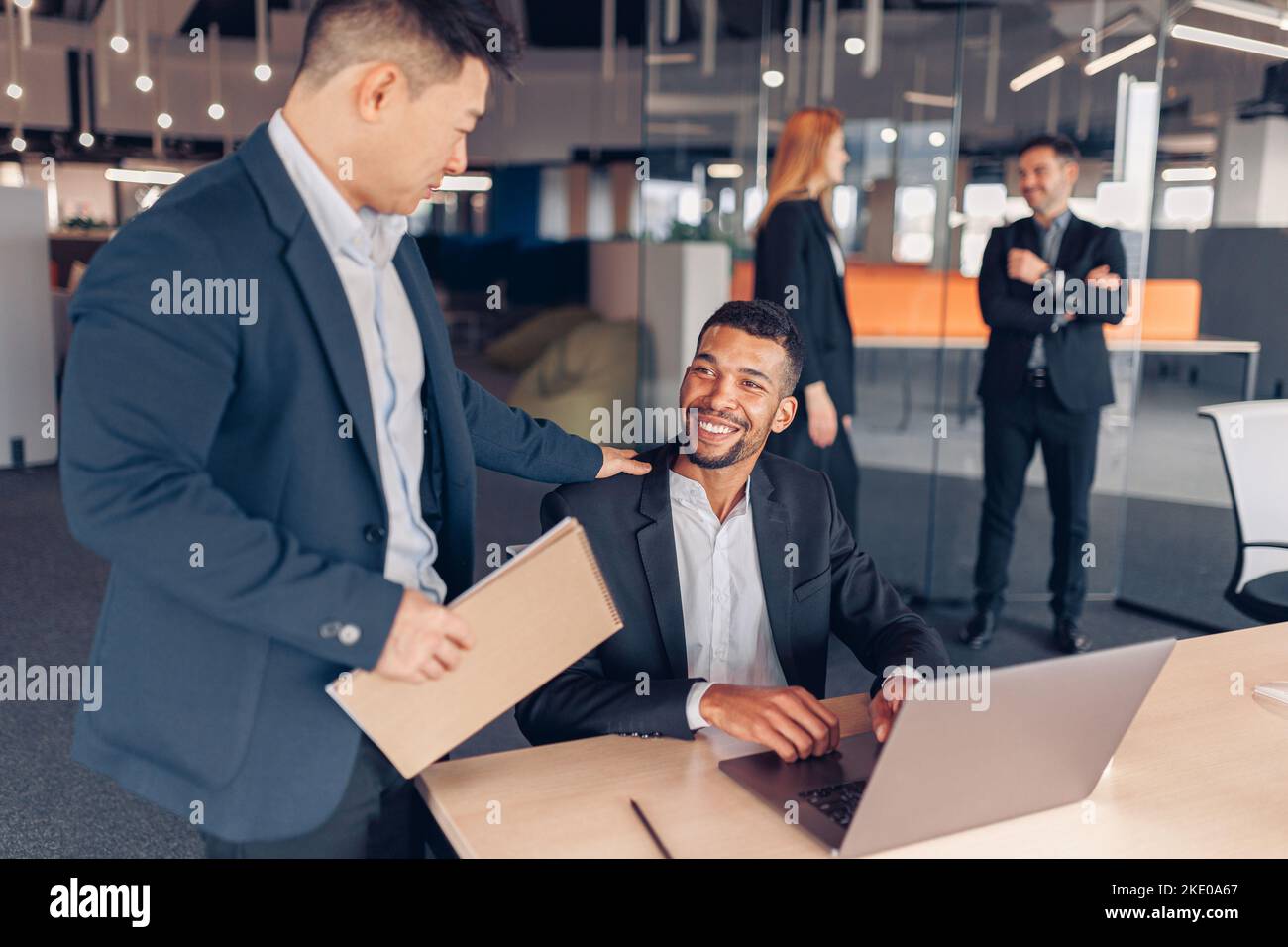 Busy multiethnic coworkers cooperating and working together at office ...