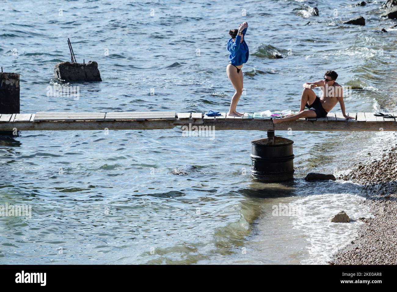 Young couple are seen while sunbathing because of unseasonably warm ...