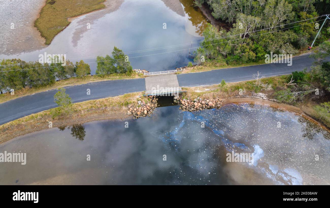 A bird's eye view of the Lake Cathie surrounded by lush trees in New ...