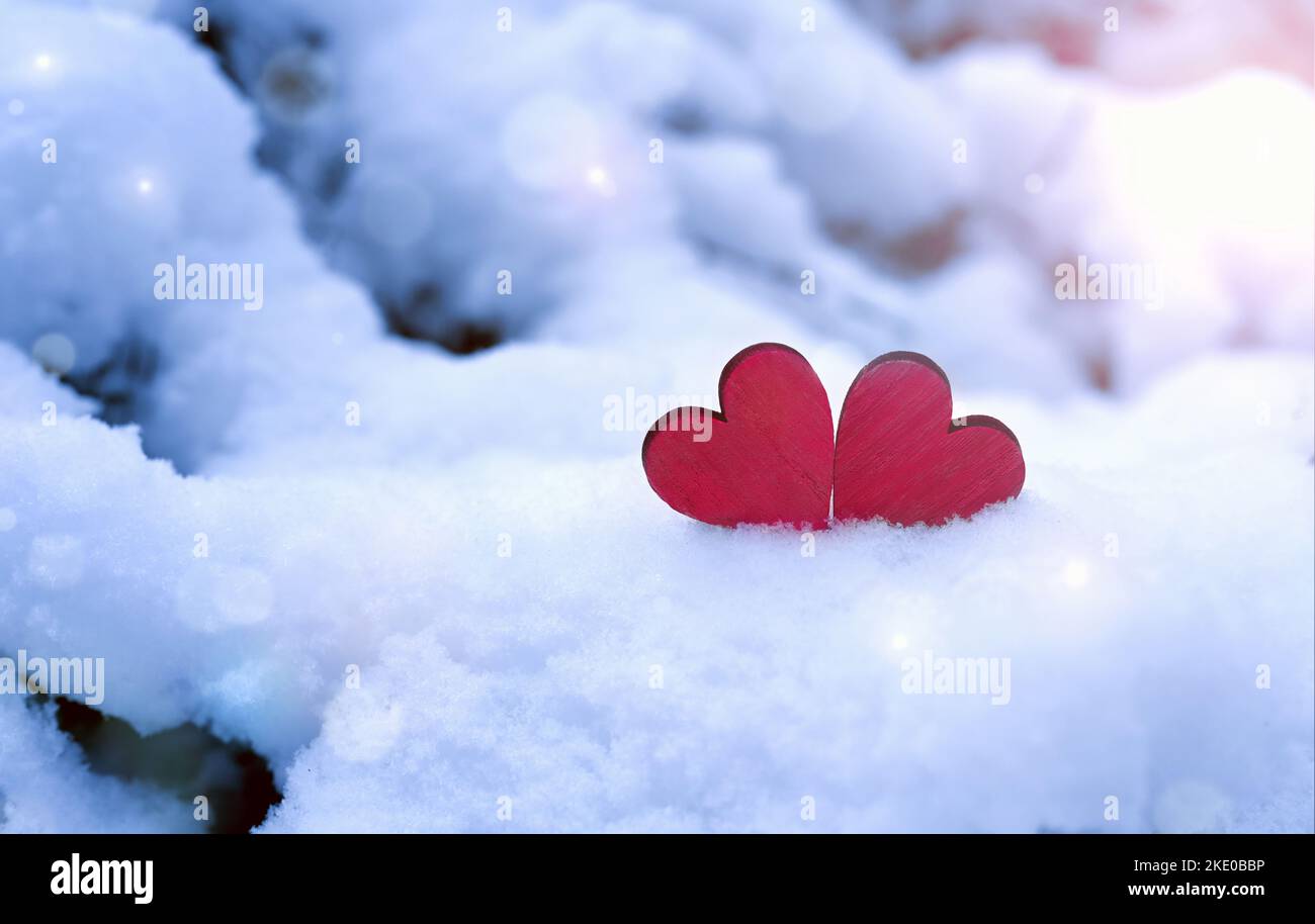 Red hearts on snowy tree branch in winter. Holidays. Happy valentines ...