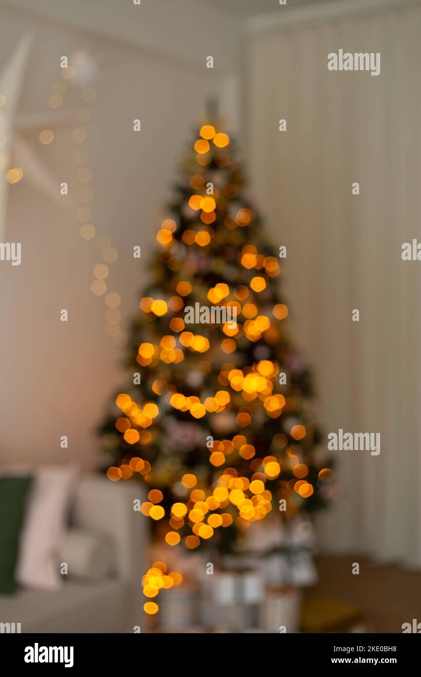 Defocused Christmas tree. Christmas tree silhouette with garland lights ...