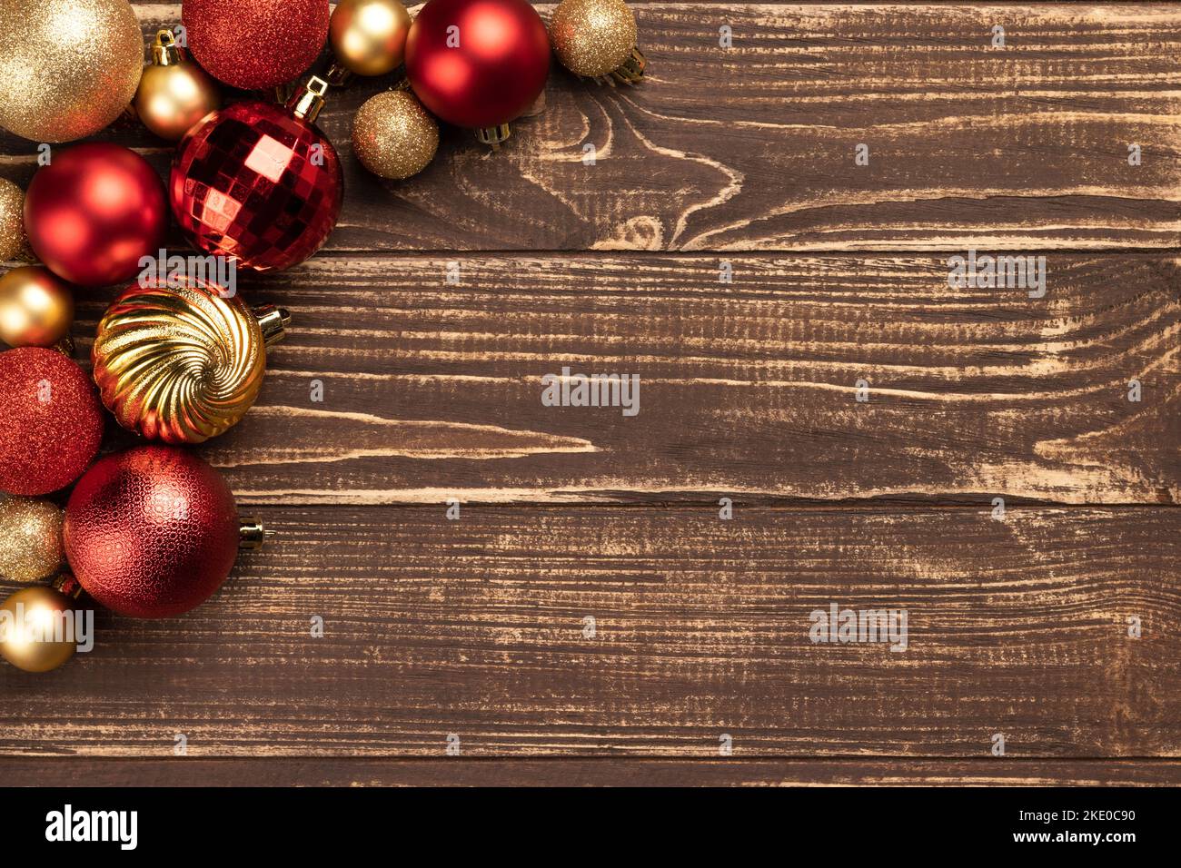 Christmas card with red and golden decoration balls on wooden ...
