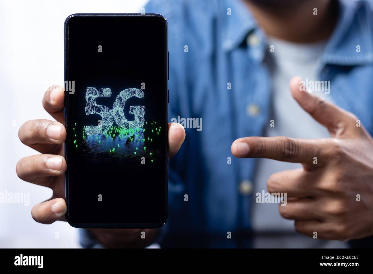 Close up of a smart phone showing 5G network held in hand by a male ...