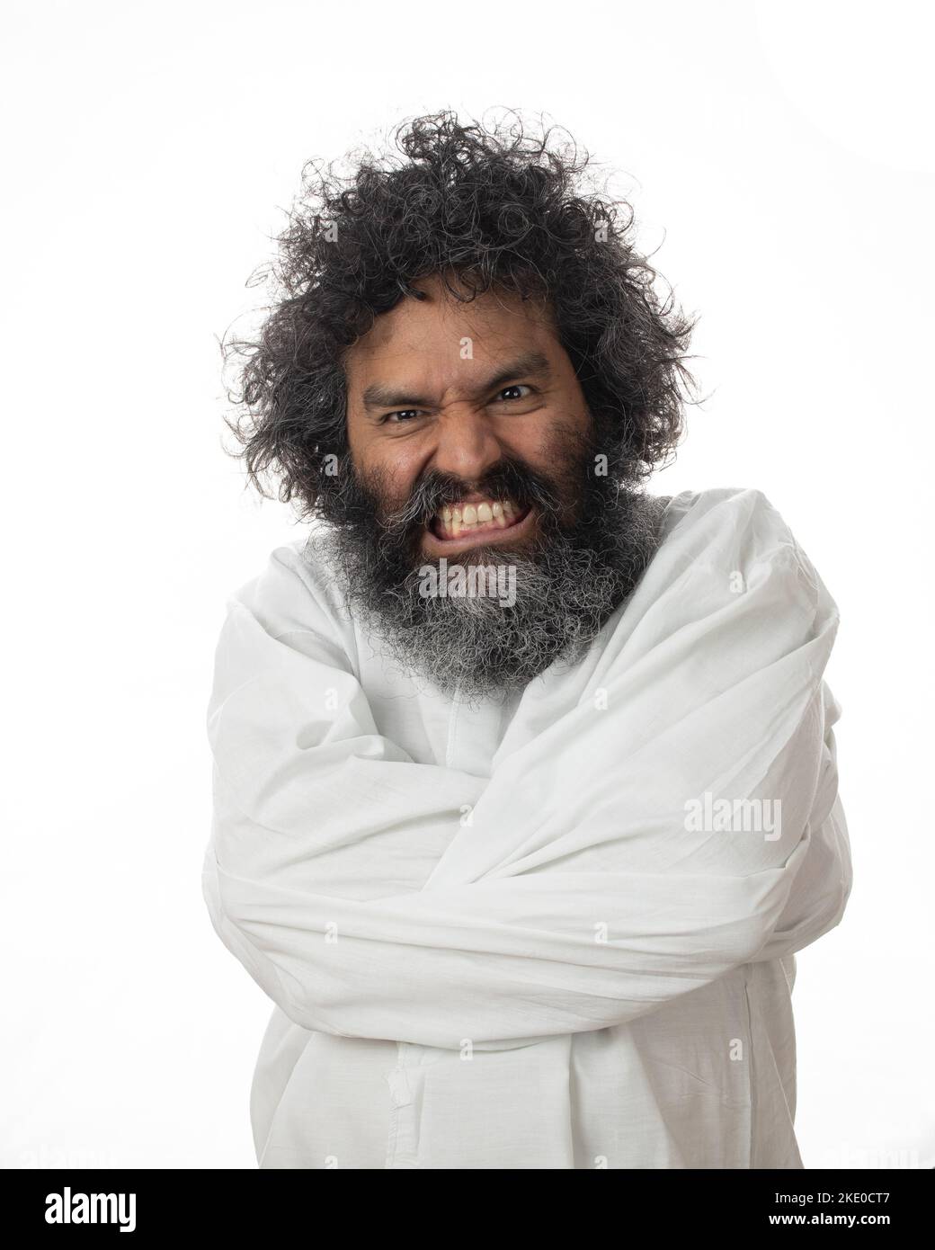 A vertical shot of a psychopath going crazy with rage in a straitjacket ...