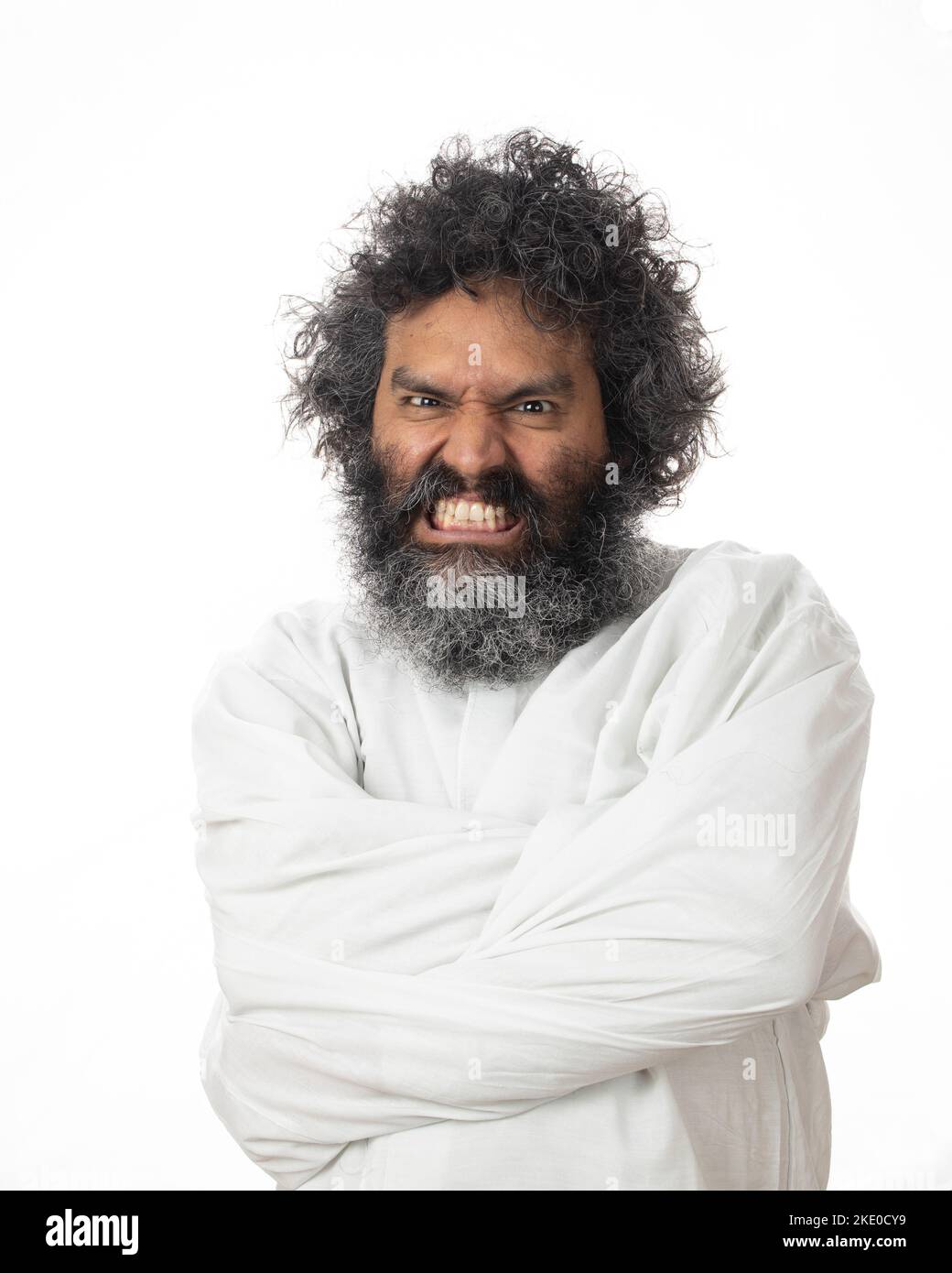 A vertical shot of a male psychopath grinding teeth in a straitjacket ...