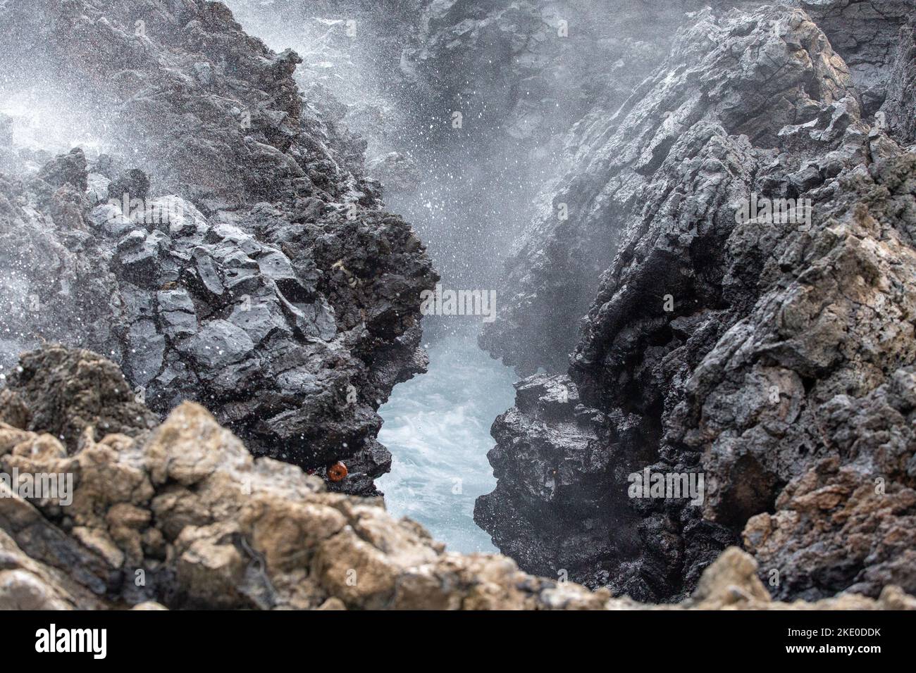The ocean wave crashing into the rocks and splashing Stock Photo - Alamy