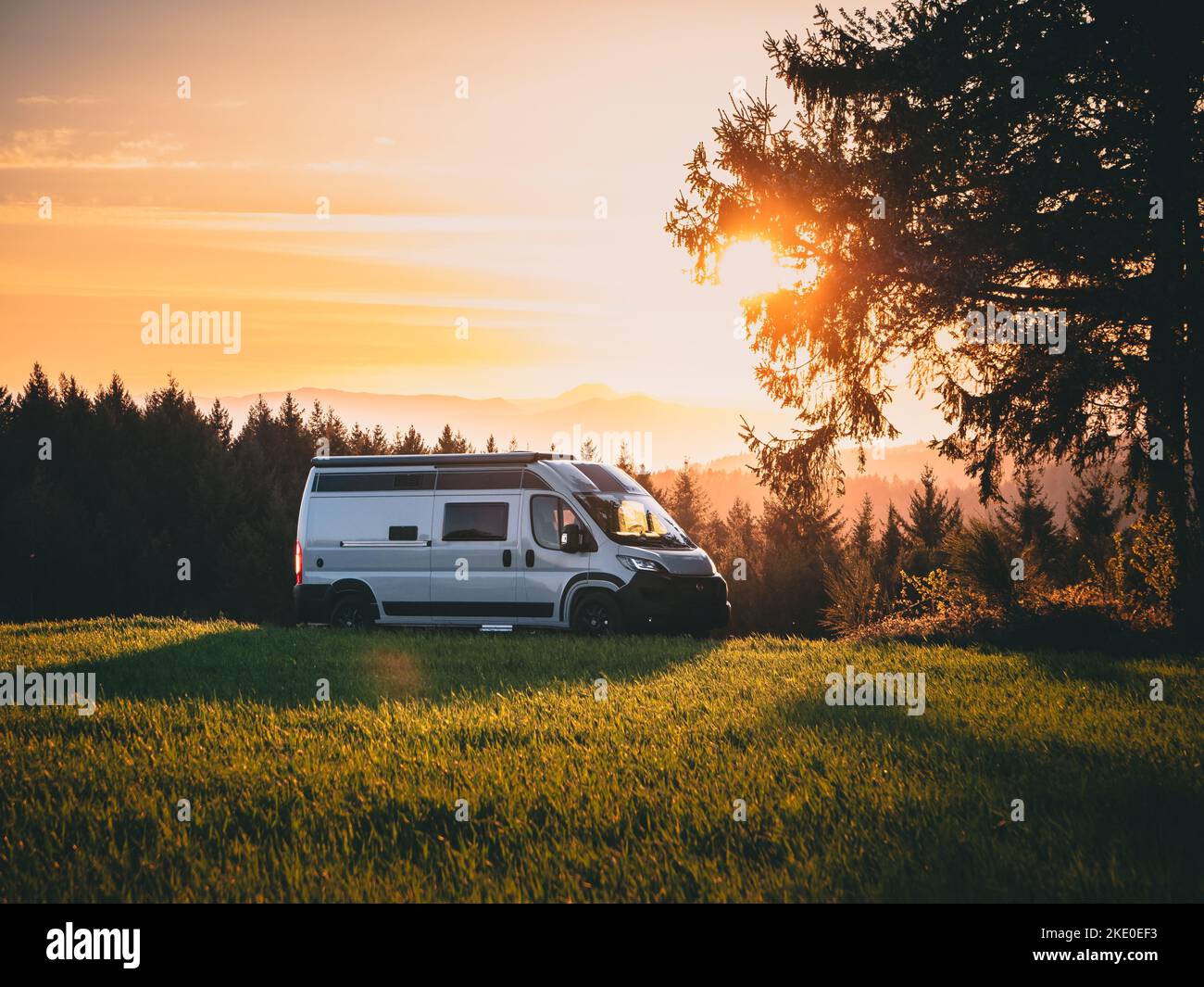 A dazzling sunset view with a campervan parked in the Black Forest ...