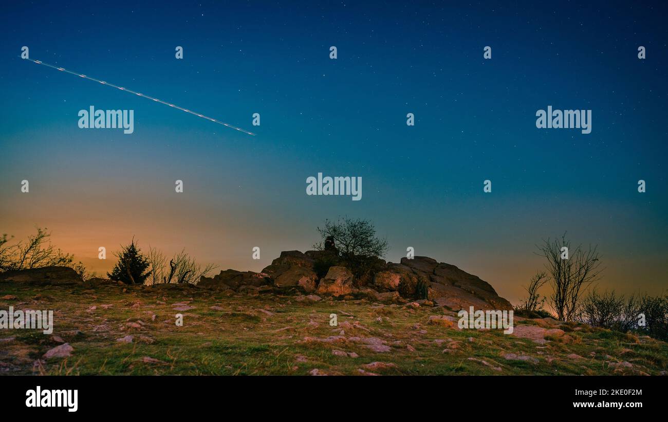 A shining meteor passing through the starry sky over the Taunus forest ...