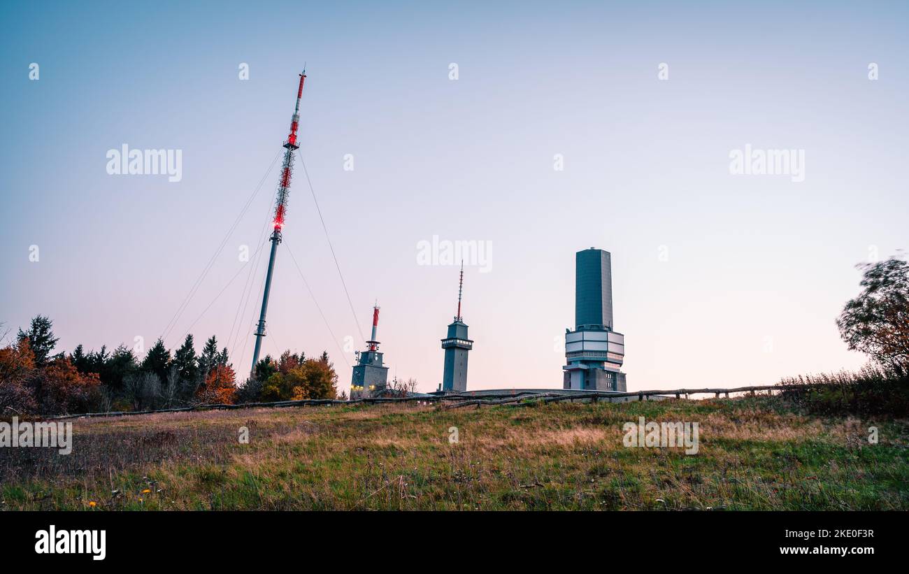 A tall tower and modern high buildings in the evening in Hessen ...