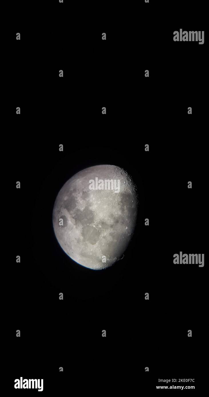 A vertical zoomed-in shot of the moon in the night sky Stock Photo - Alamy