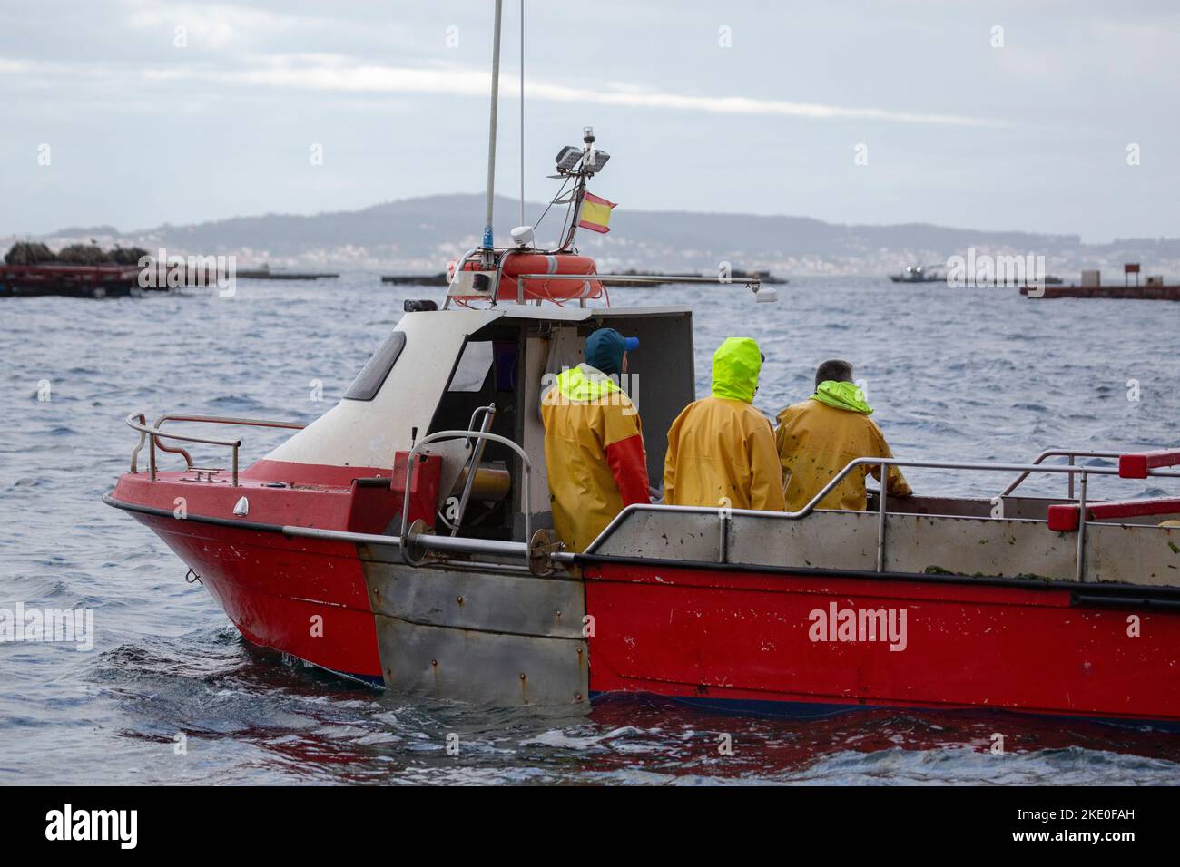 Inshore fishing sailors fish in their traditional wooden boat in the ...