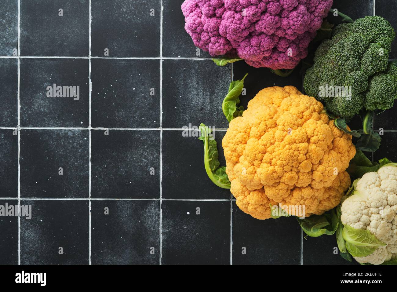 Colorful cauliflower. Various sort of cauliflower on old stone tiles ...