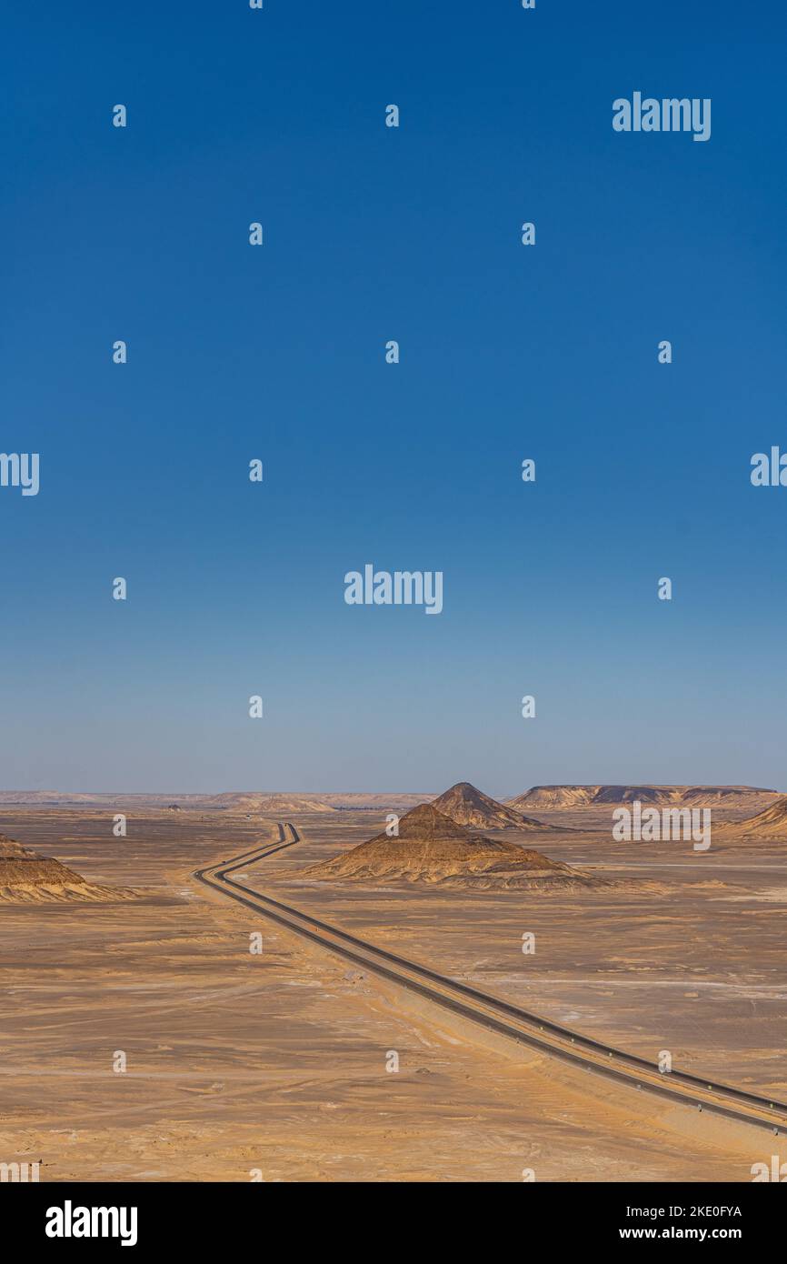 A vertical aerial shot of the road through the Black Desert, Egypt ...
