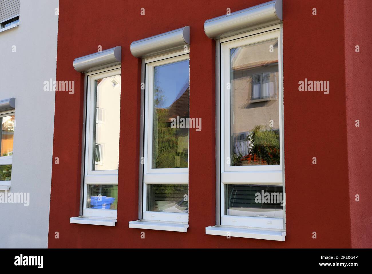 New windows with front-mounted roller shutters on a renovated old ...