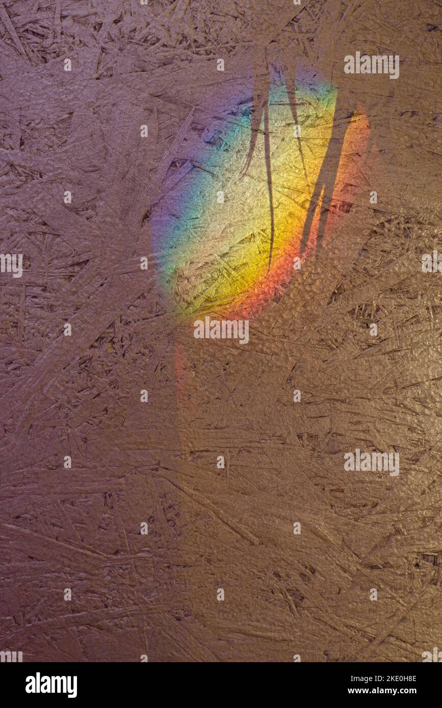 Rainbow light spot and shadows on textured plywood surface Stock Photo ...