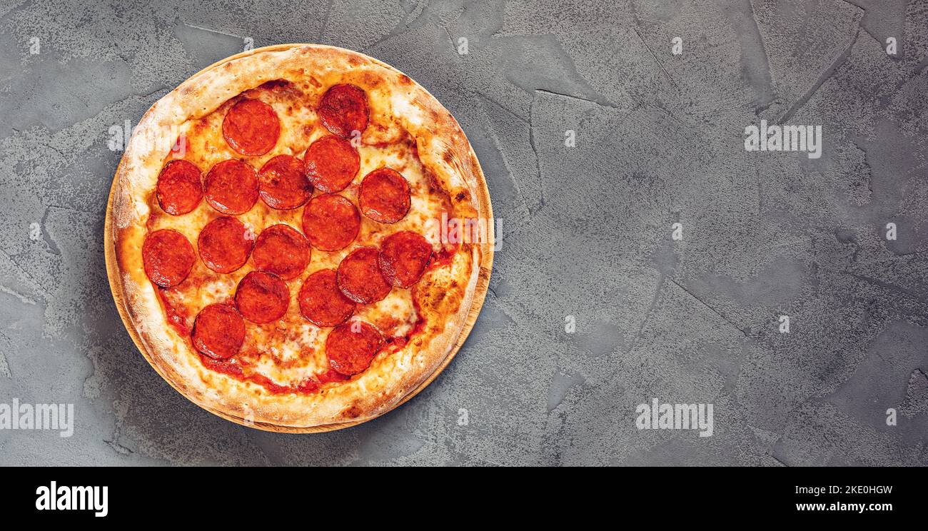 Pepperoni pizza on a gray concrete background Stock Photo - Alamy