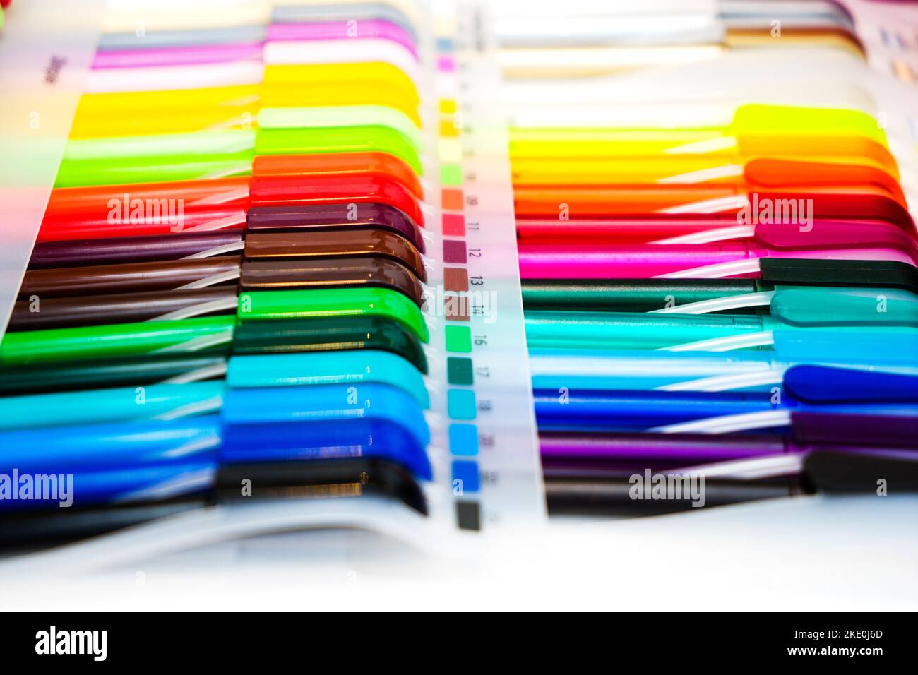 a group multi-colored plastic ballpoint pens on white table Stock Photo ...