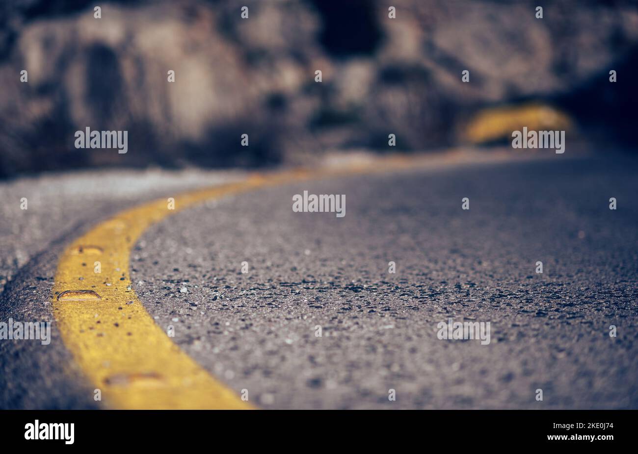 A close-up shot of the yellow road marking on the asphalt Stock Photo ...