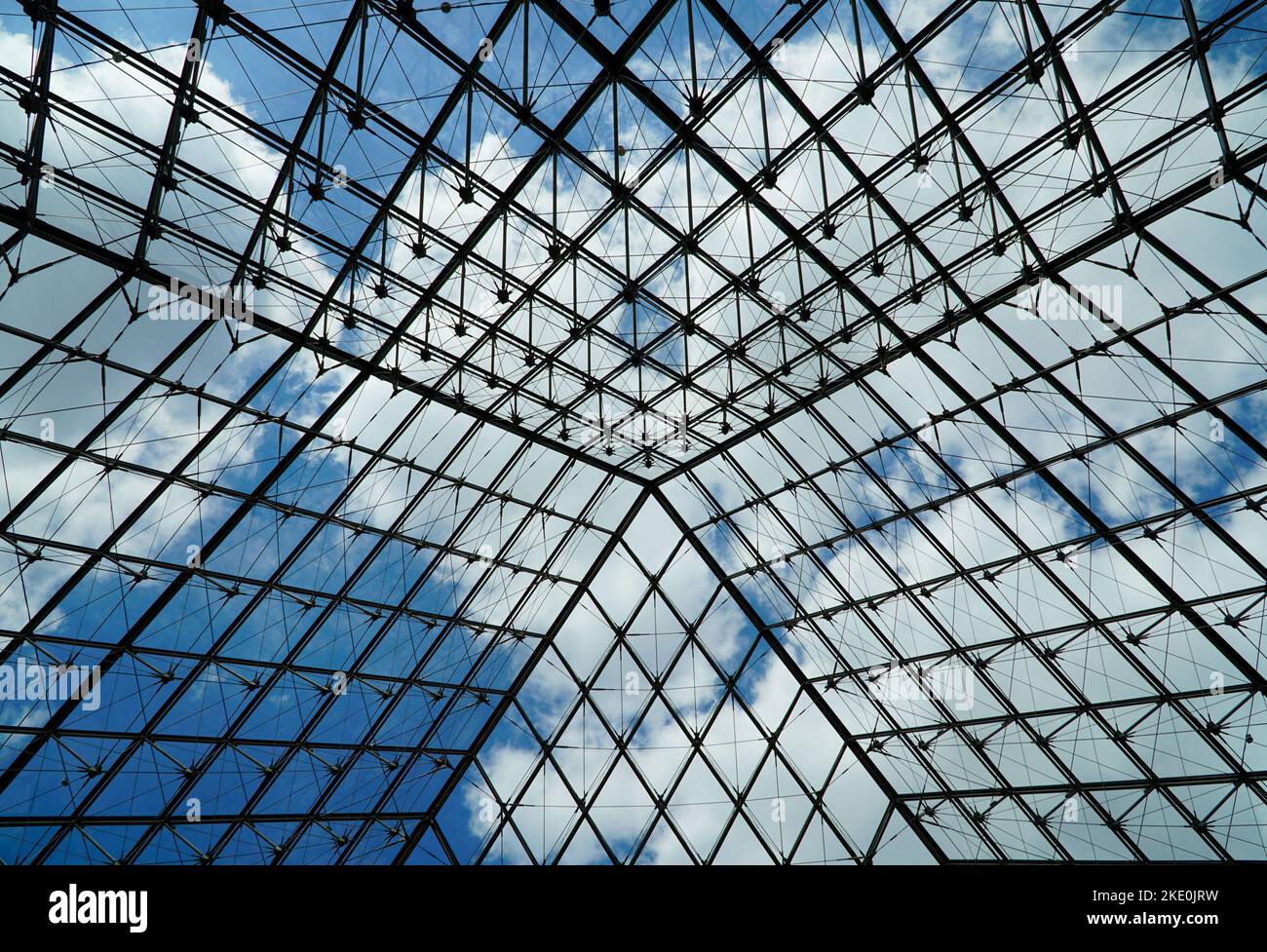 A low angle shot of the beautiful glass ceiling of the Louvre Museum ...