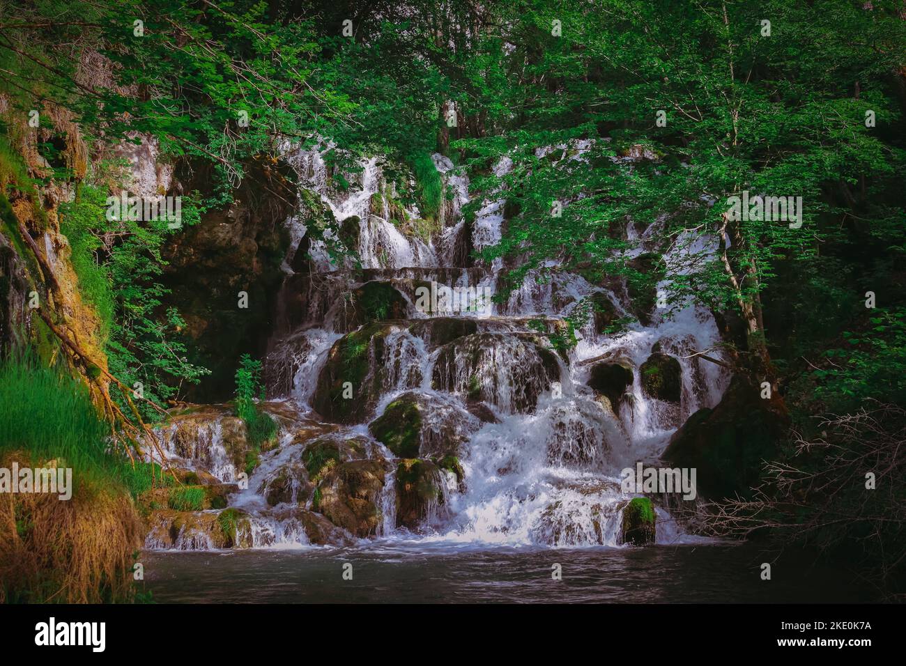 The view of water flowing down the stone cascade in the forest Stock ...