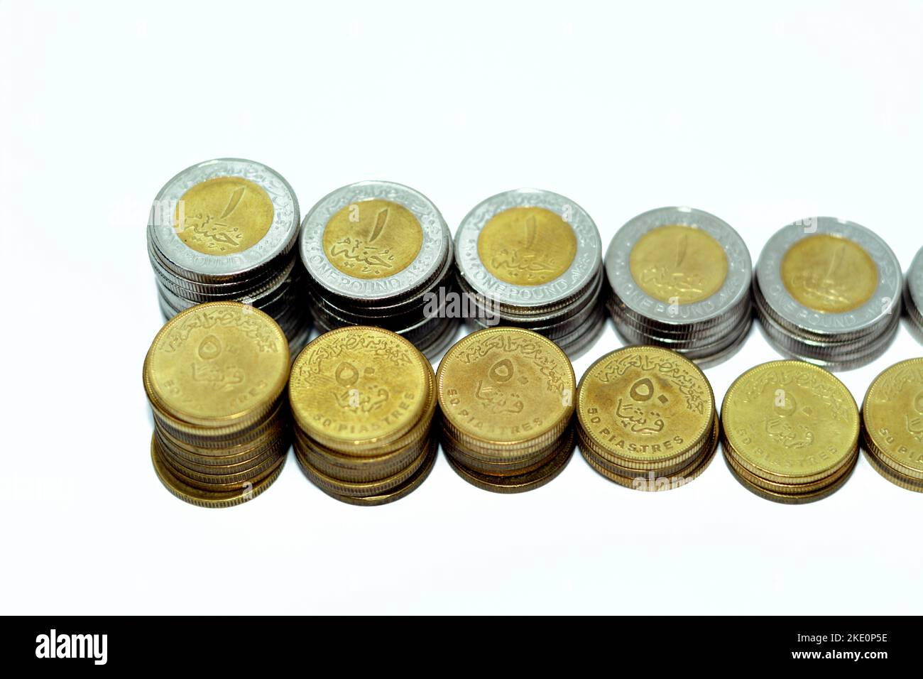 Stacks of 1 LE EGP one Egyptian pound coins cash and 50 fifty Egyptian ...