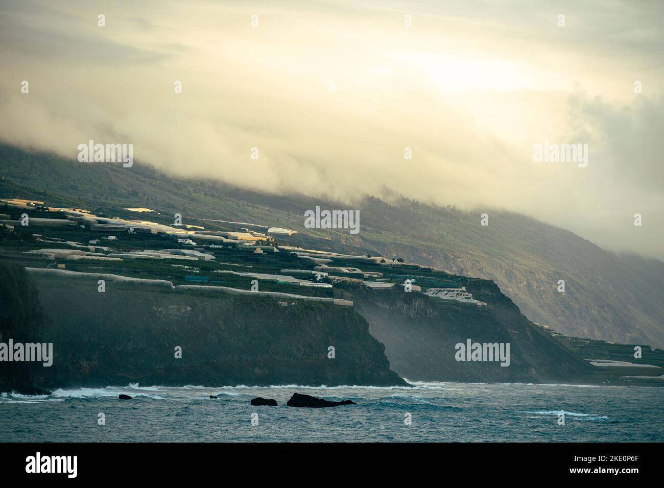 A dramatic landscape of banana field farms on a rocky cliff edge with ...