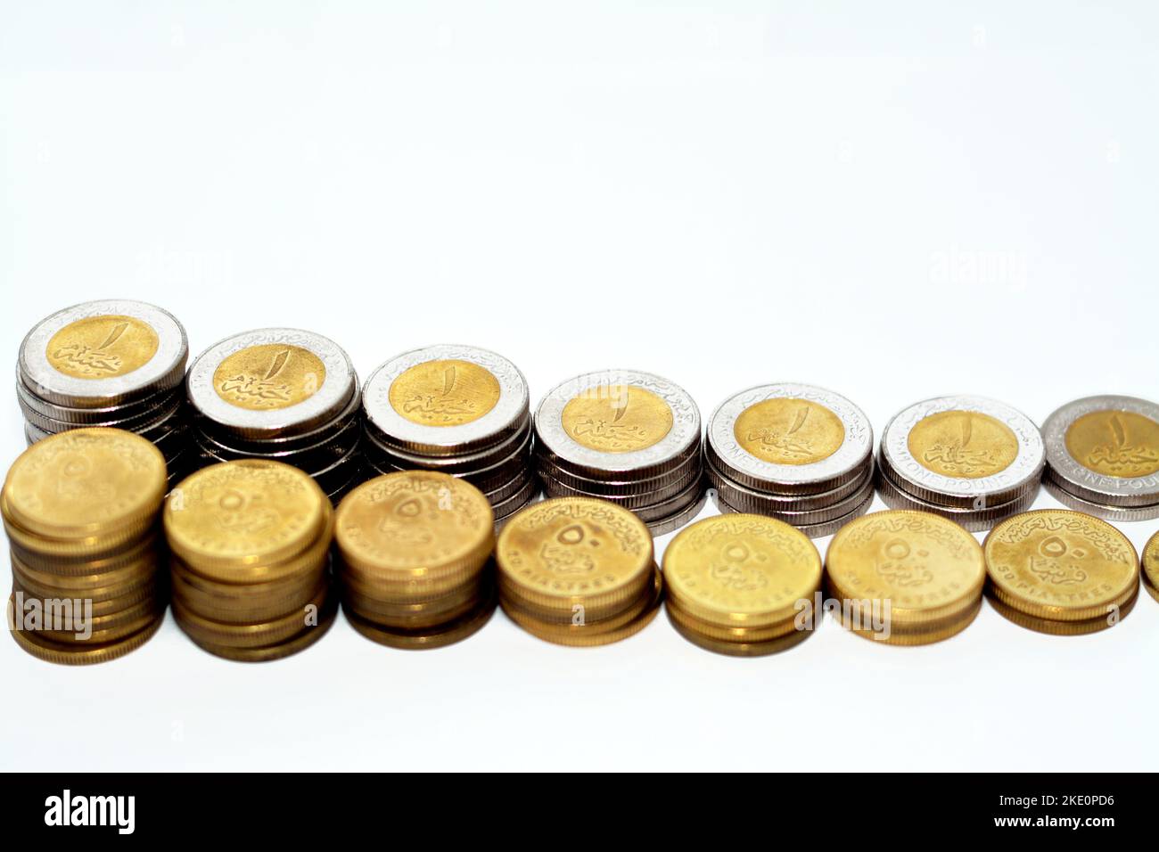 Stacks of 1 LE EGP one Egyptian pound coins cash and 50 fifty Egyptian ...