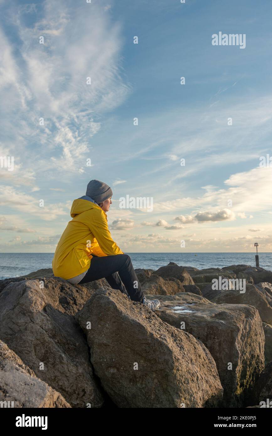 Female tourist sitting on some rocks hi-res stock photography and ...