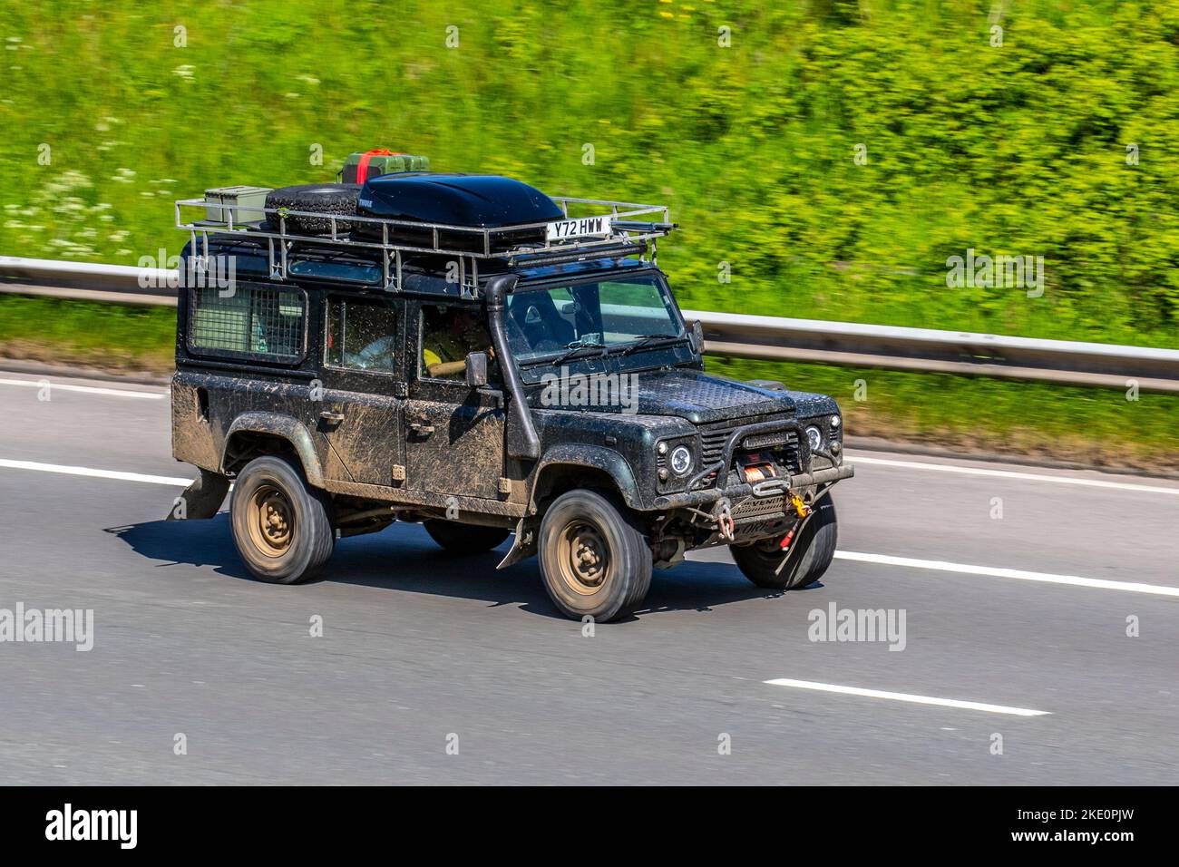 2001 Land Rover Mud splattered 4x4 off-road, dirty SUV travelling on ...